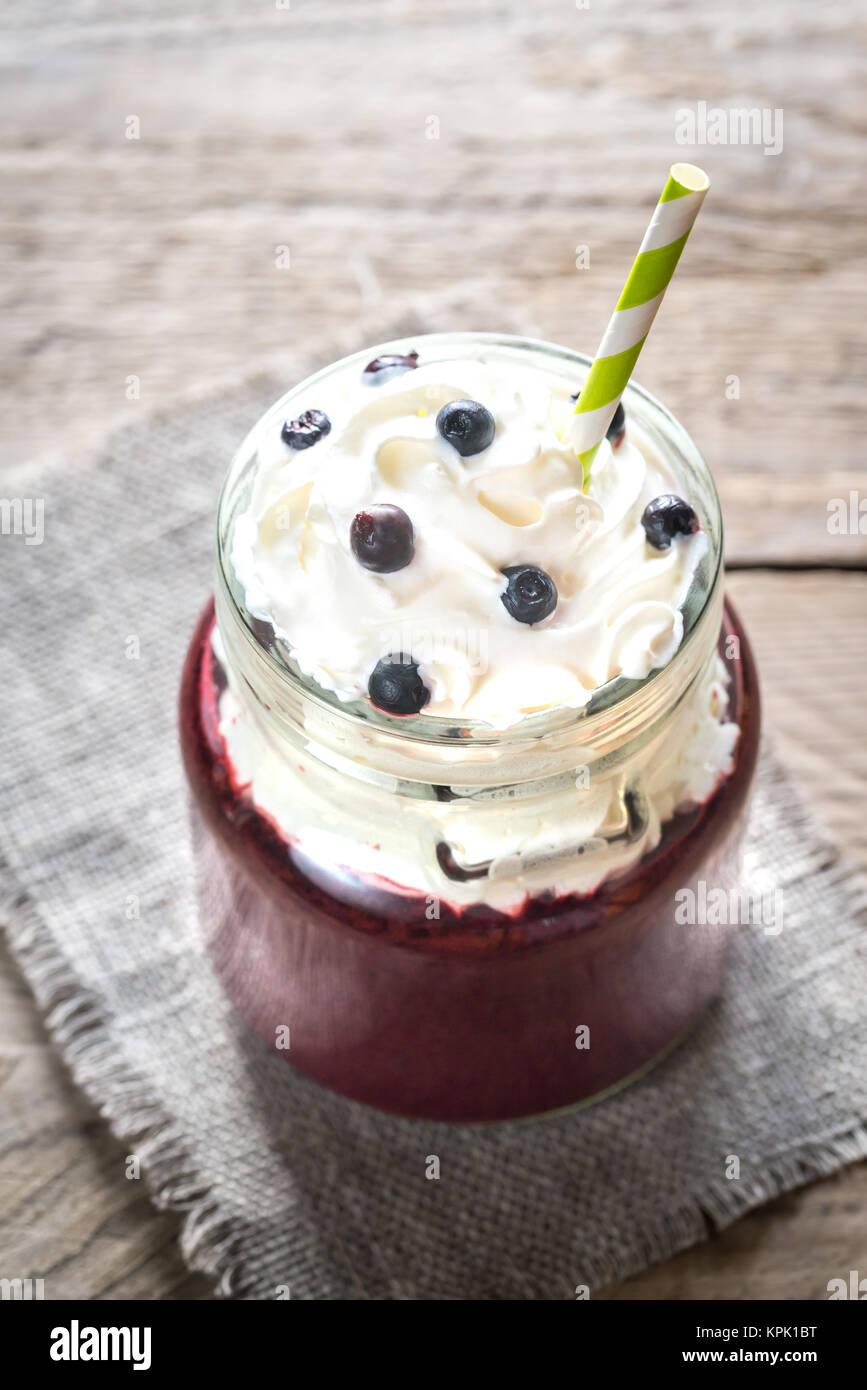 Bilberry smoothie with whipped cream Stock Photo - Alamy