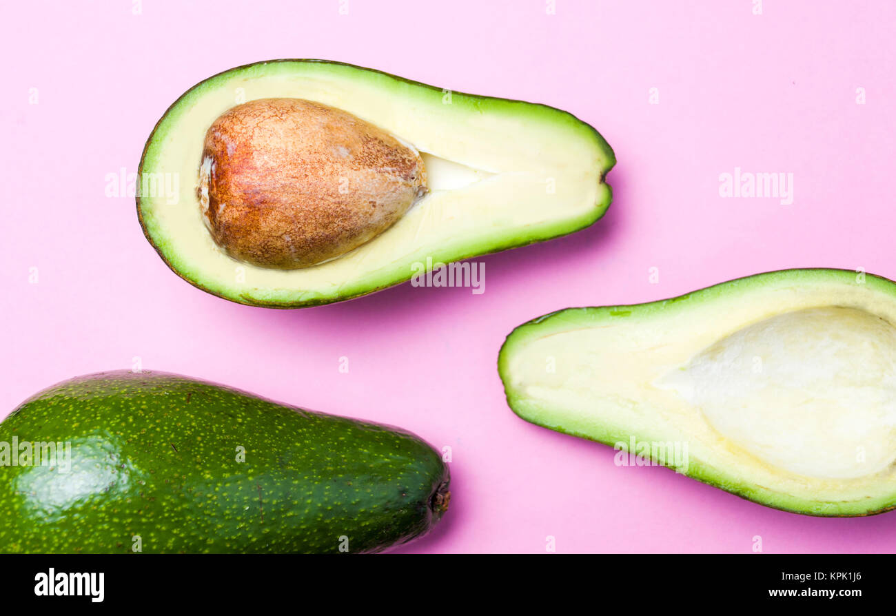 Avocado slices on pink background. Healthy food Stock Photo - Alamy