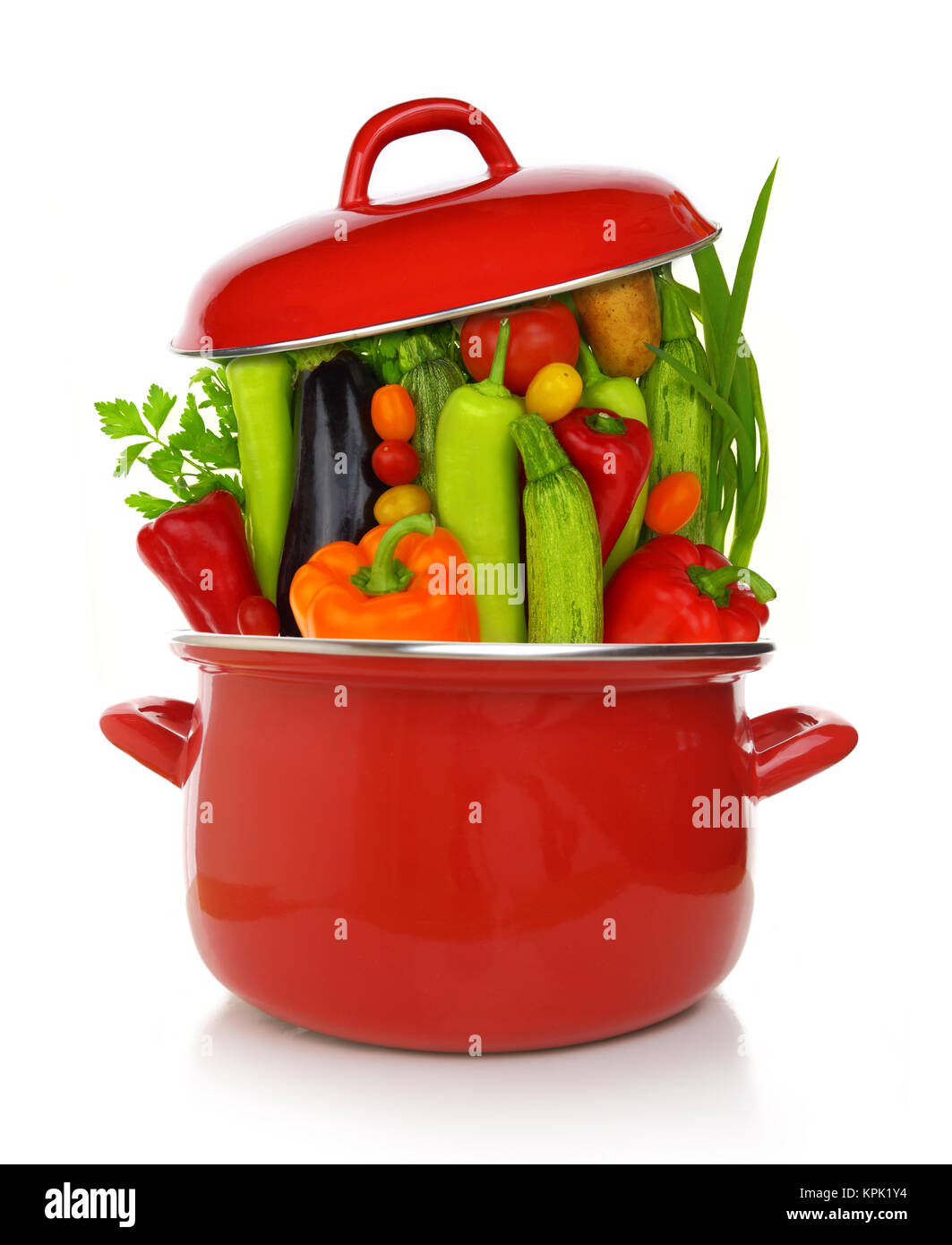 Colorful vegetables in a red cooking pot isolated on white background ...