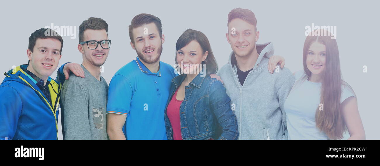 group of smiling friends staying together and looking at camera ...