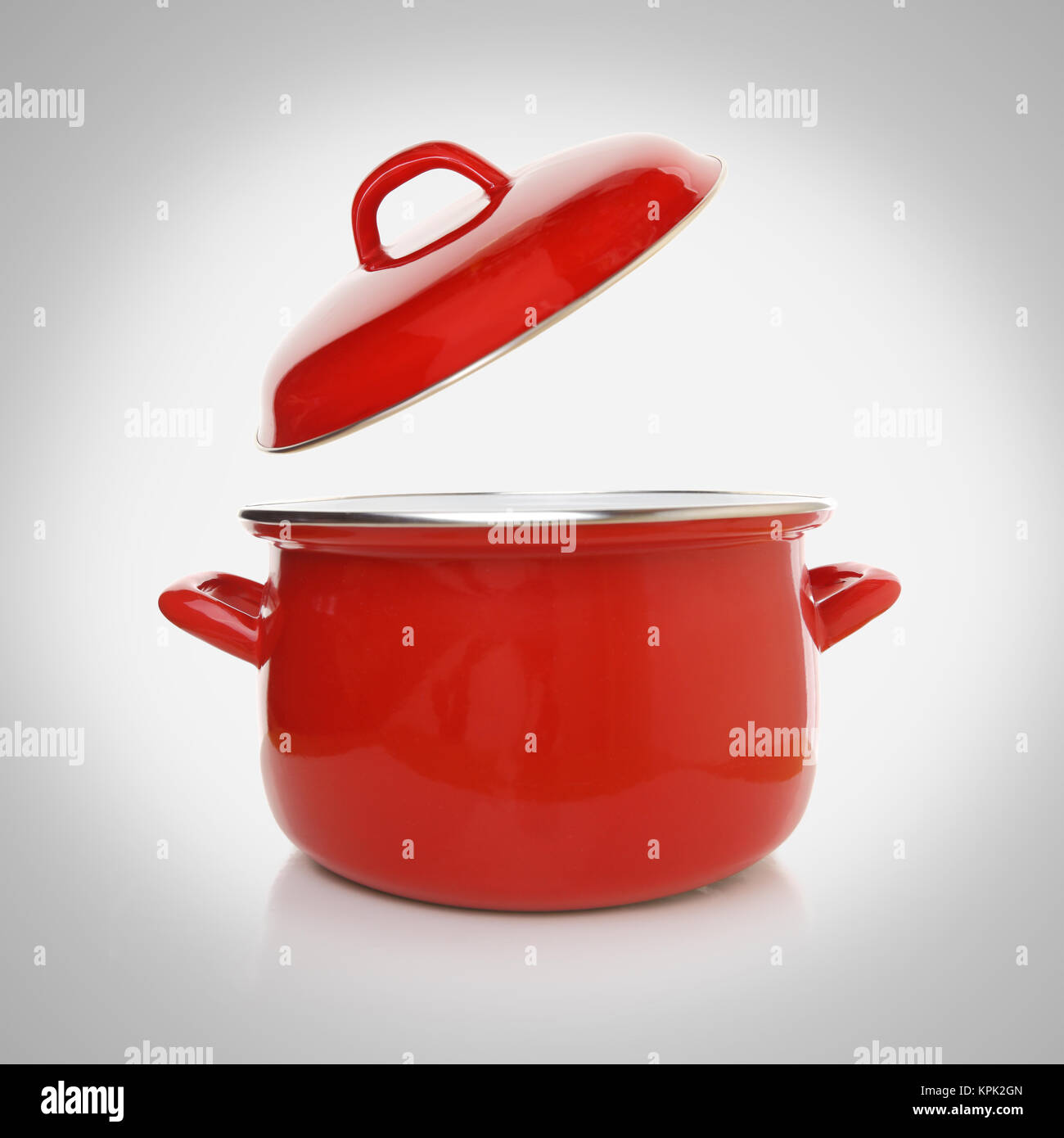 Red cooking pot on grey background Stock Photo - Alamy