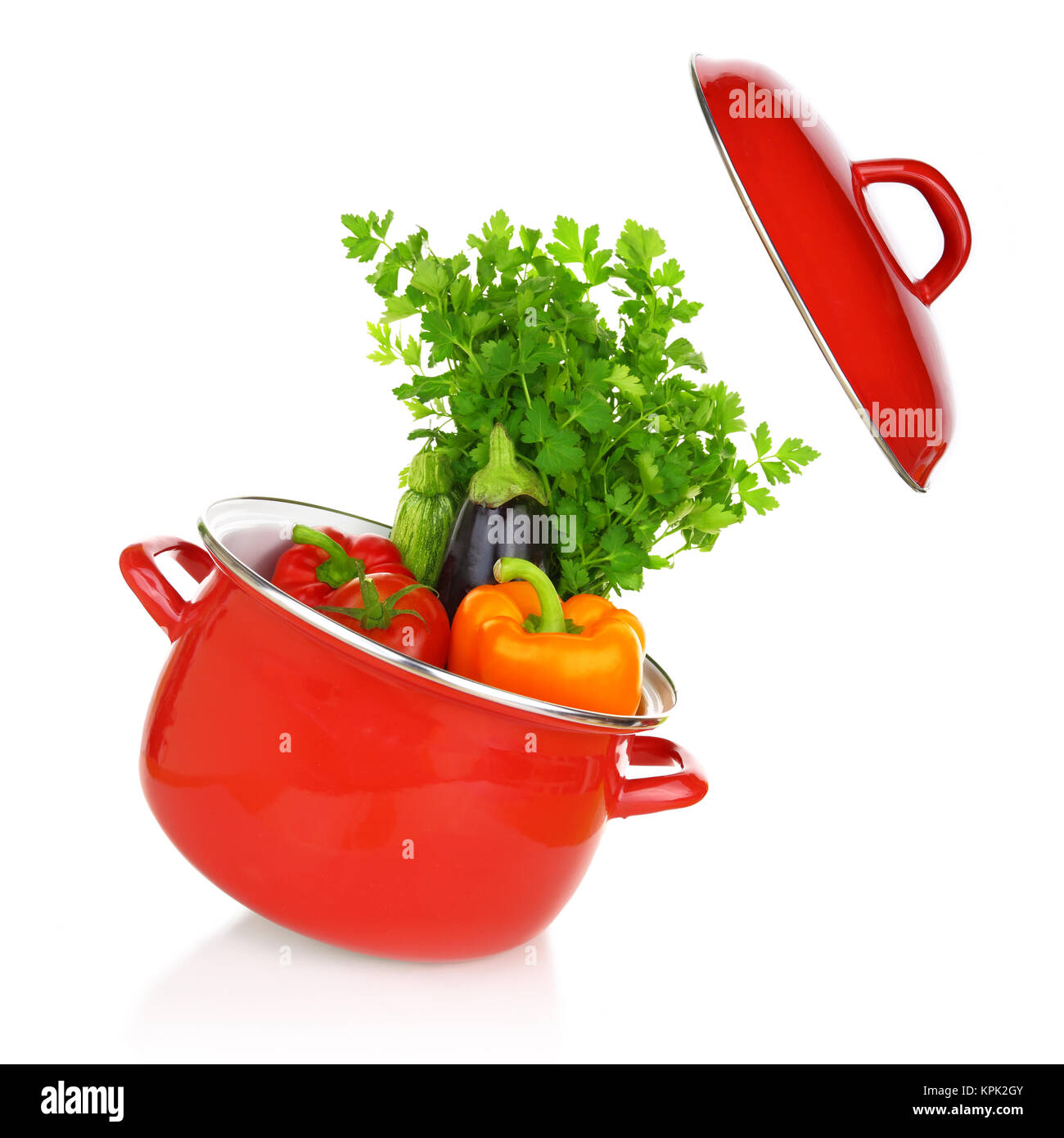 Colorful vegetables in a red cooking pot isolated on white background ...