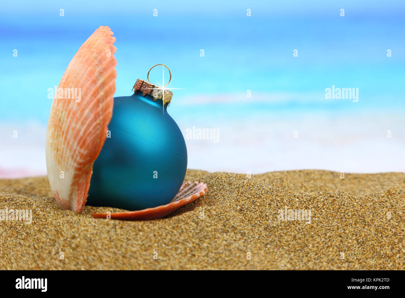 Christmas ball in a sea shell on the beach Stock Photo - Alamy