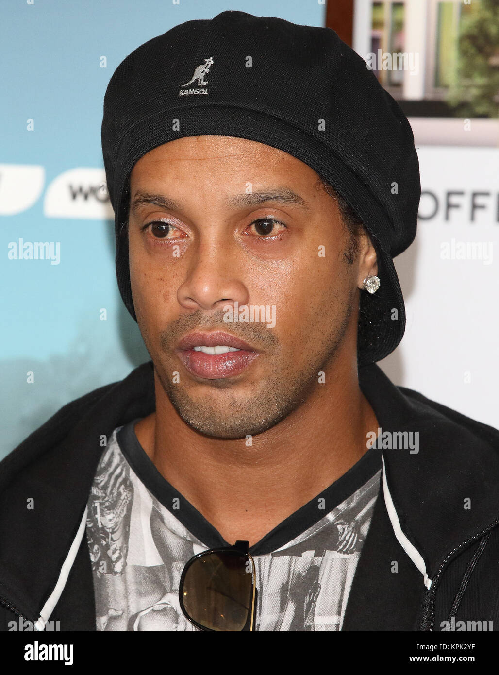 Brazilian footballer Ronaldinho poses for a photocall with artist ...
