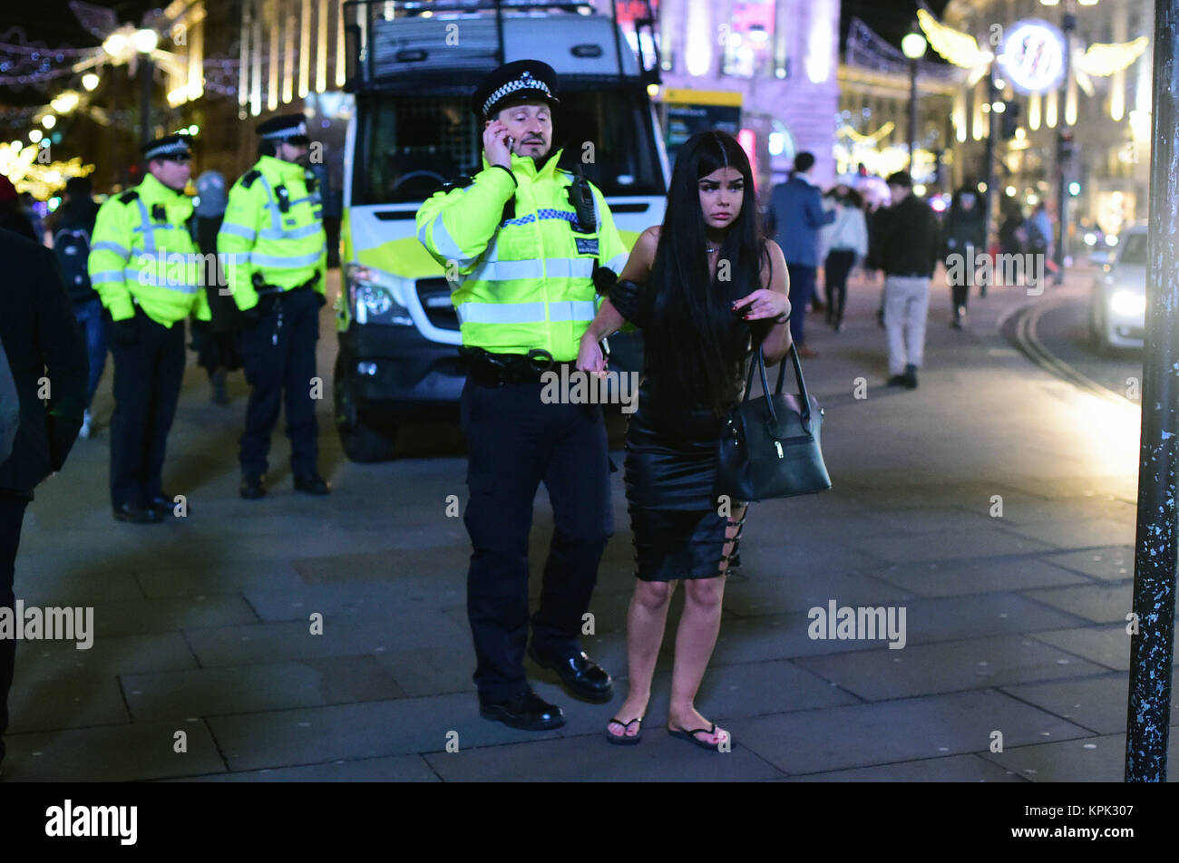 Police assist a lady in Piccadilly Circus on the penultimate Friday ...