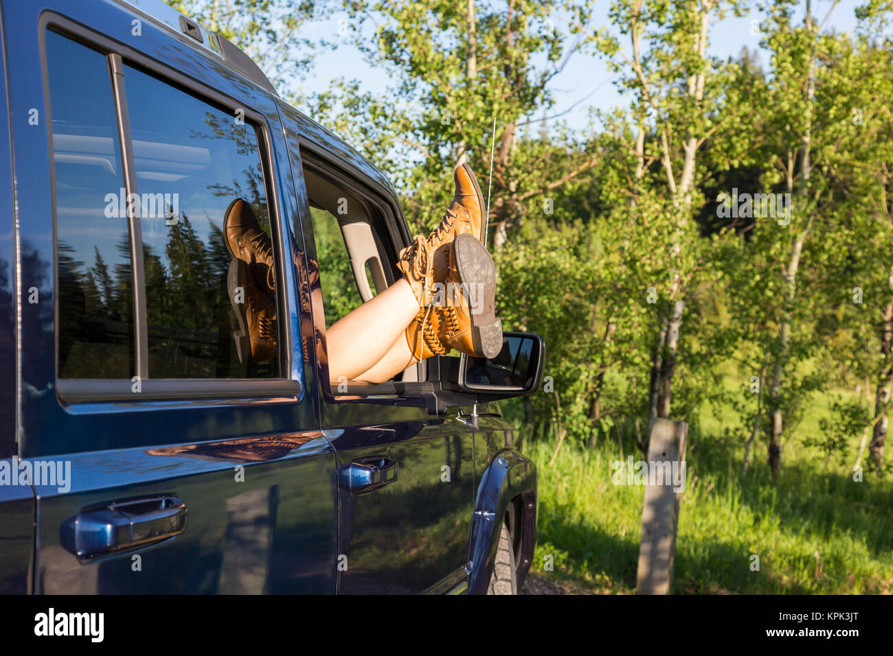 A female passenger with her feet out the window of the vehicle during a ...