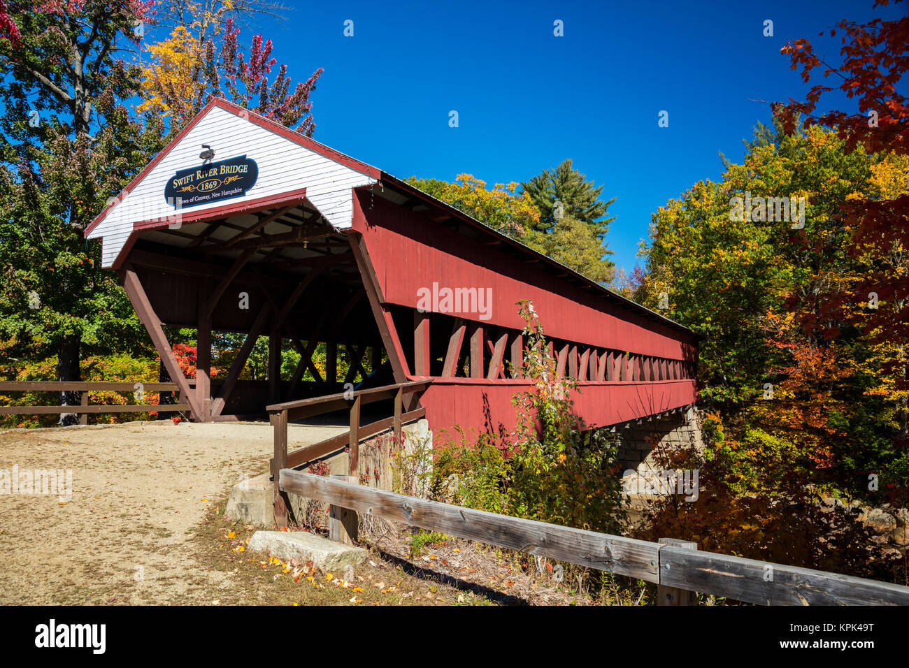 Swift River covered bridge on a back country road in autumn, White ...