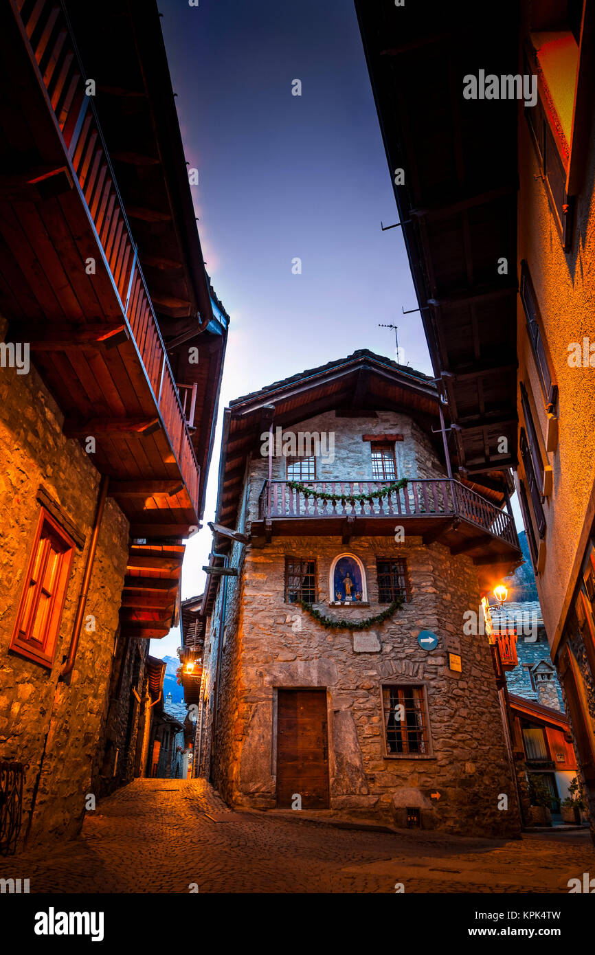 Old stone buildings and ancient cobblestone streets illuminated at dusk ...
