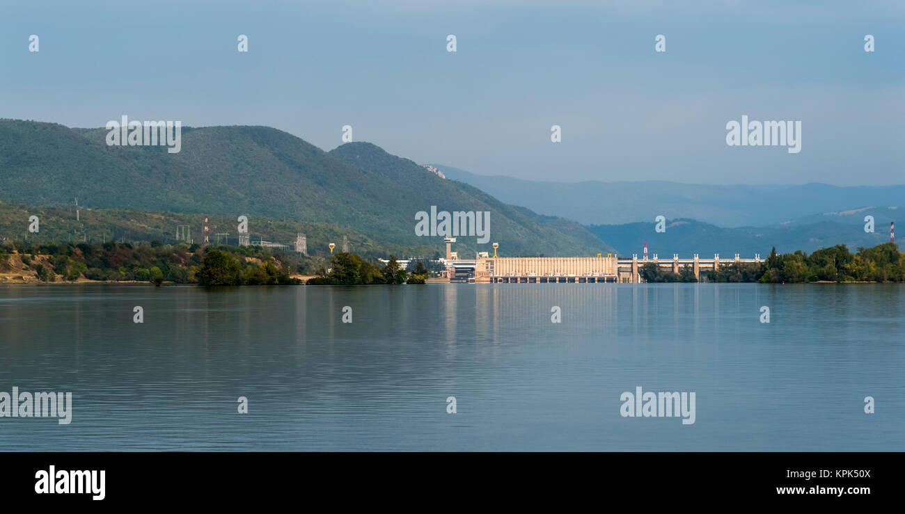 A bridge and dam on the Danube River with hills in the distance, the ...