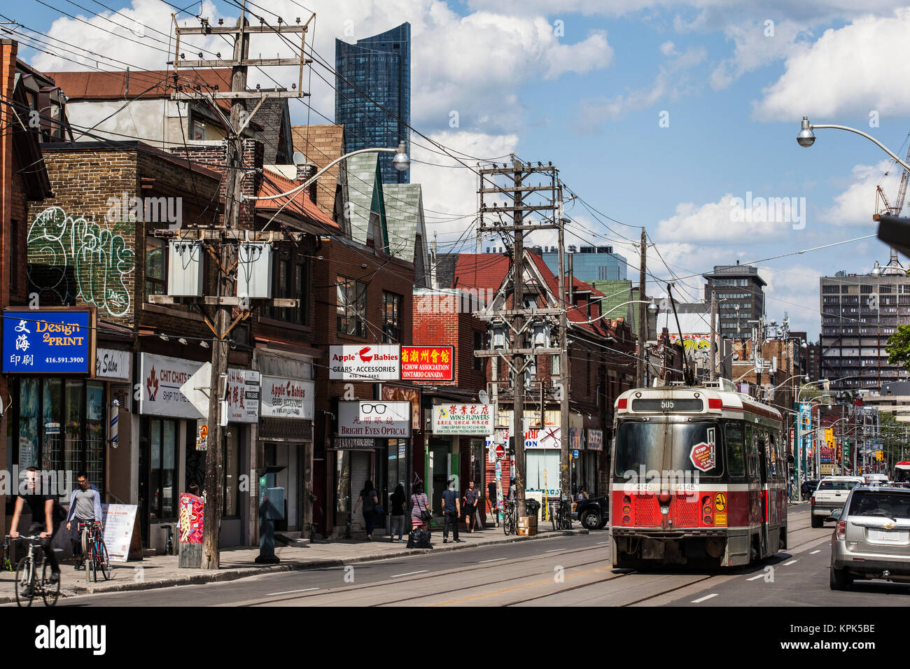Streetcar, shops and pedestrians along a street; Toronto, Ontario ...