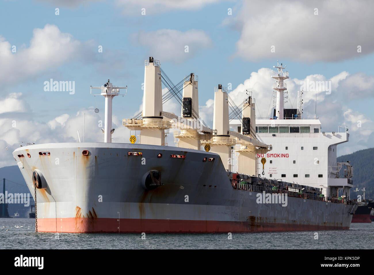 A large container ship in Burrard Inlet waiting to dock at the Port of ...