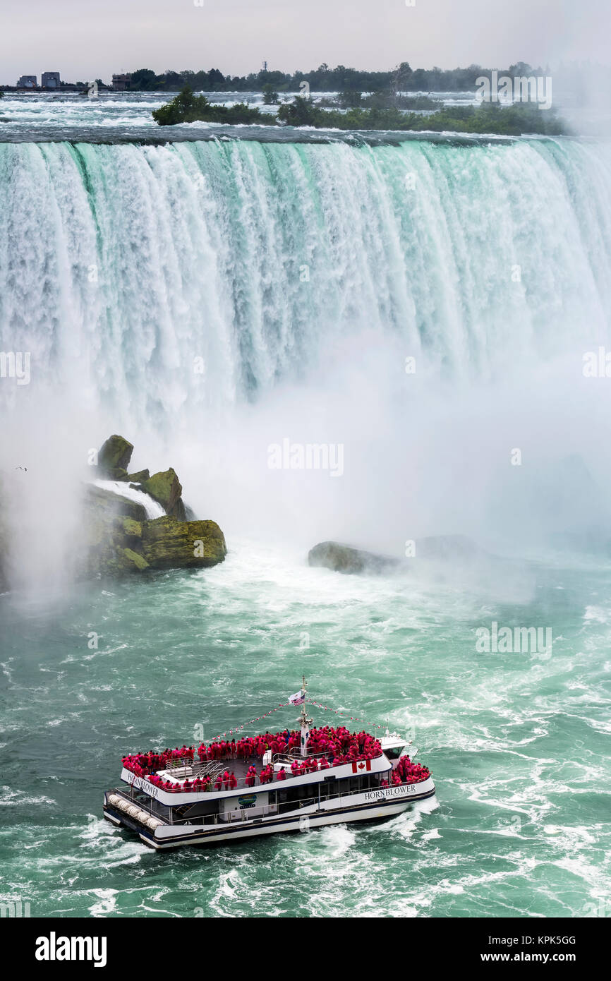 Close-up of Niagara Falls with tourist boat going towards the falls ...