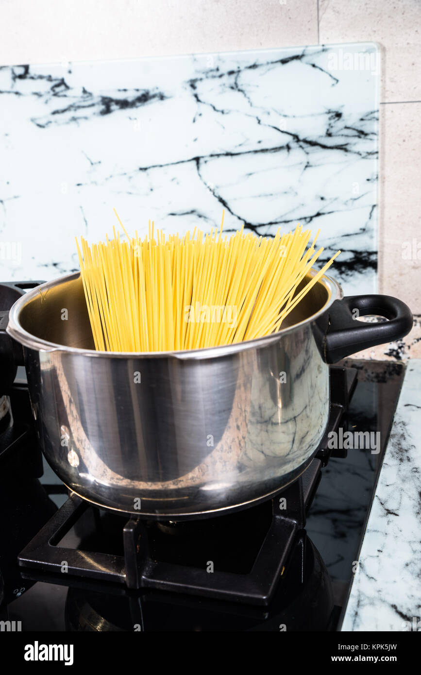 Pasta inside a pot ready to be cooked Stock Photo - Alamy
