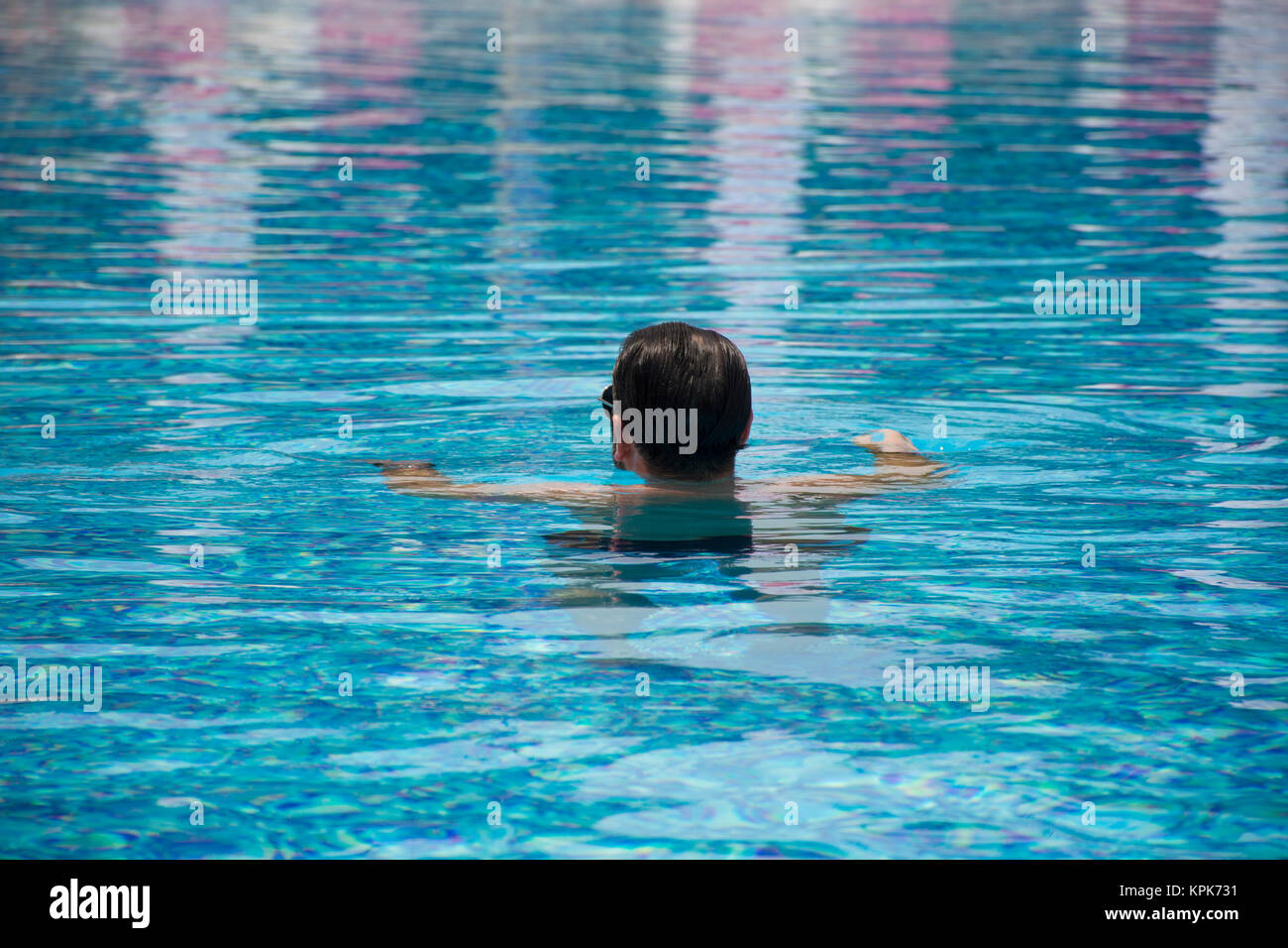 Man chilling in swimming pool hi-res stock photography and images - Alamy
