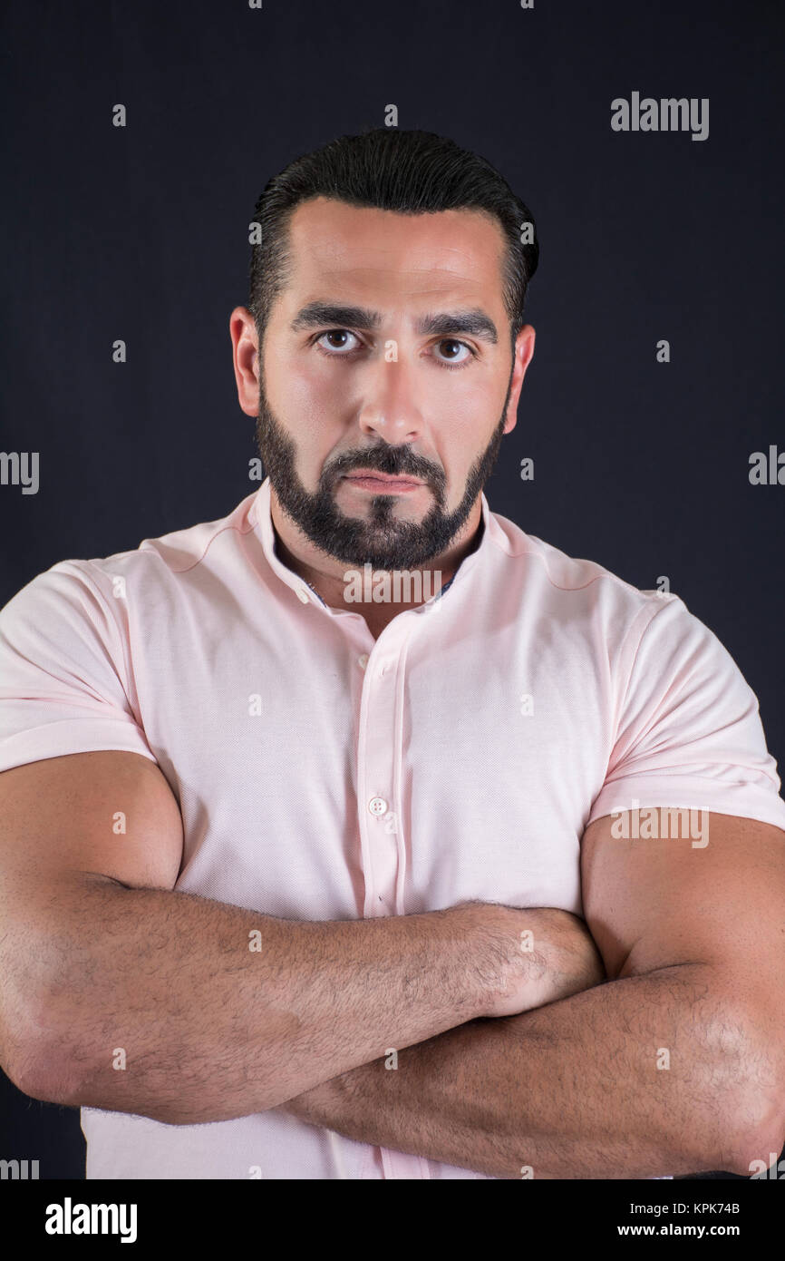 Serious man arms folded staring Stock Photo - Alamy