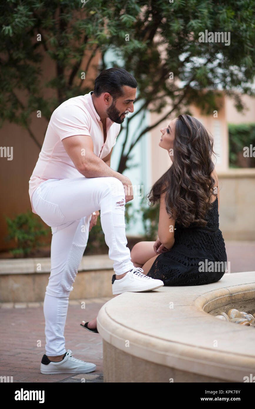 Man and woman talking outdoors Stock Photo - Alamy