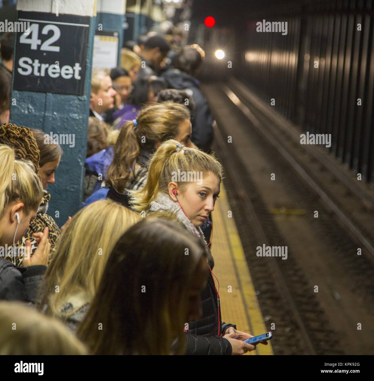 Workers wait for a subway train during the evening rush hour at the ...