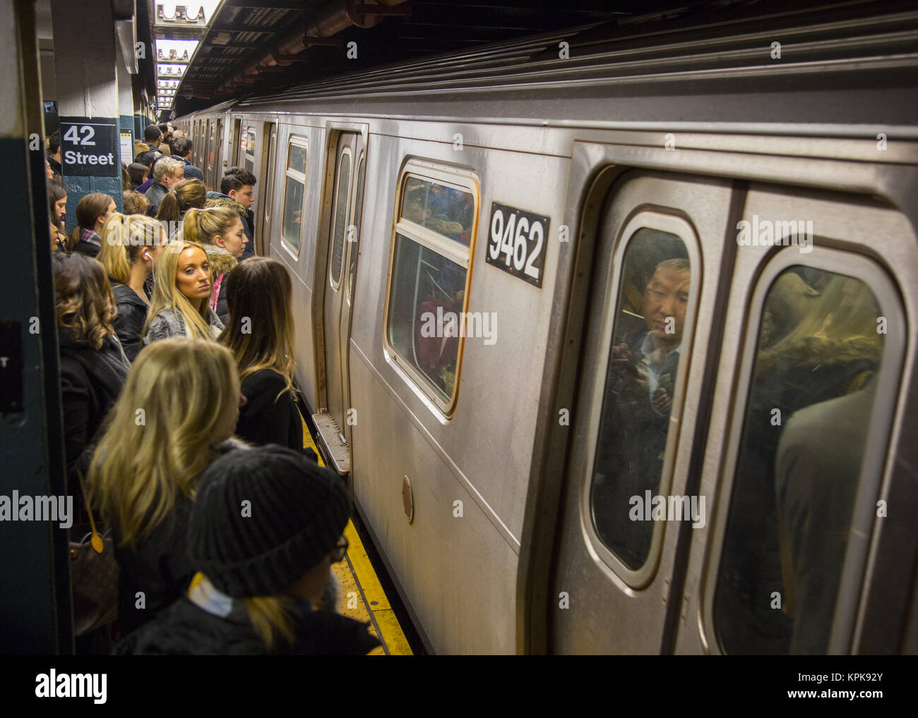 Workers wait for a subway train during the evening rush hour at the ...