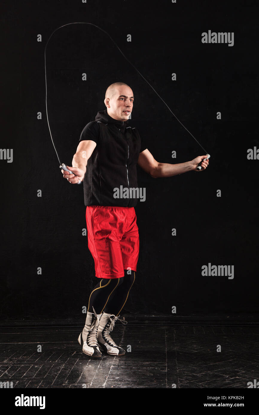 The legs of muscular man with skipping rope Stock Photo - Alamy