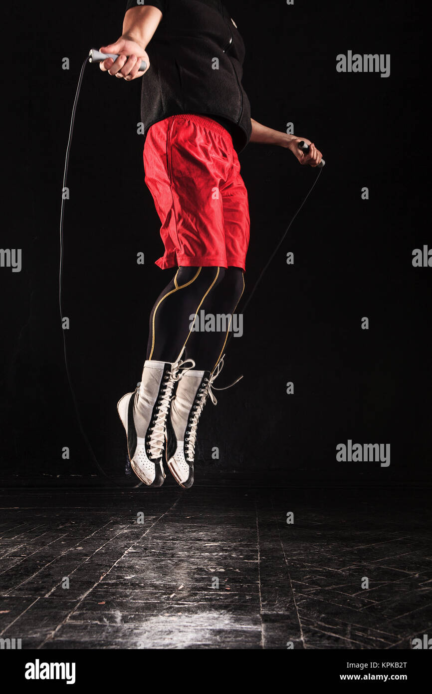 The legs of muscular man with skipping rope Stock Photo - Alamy