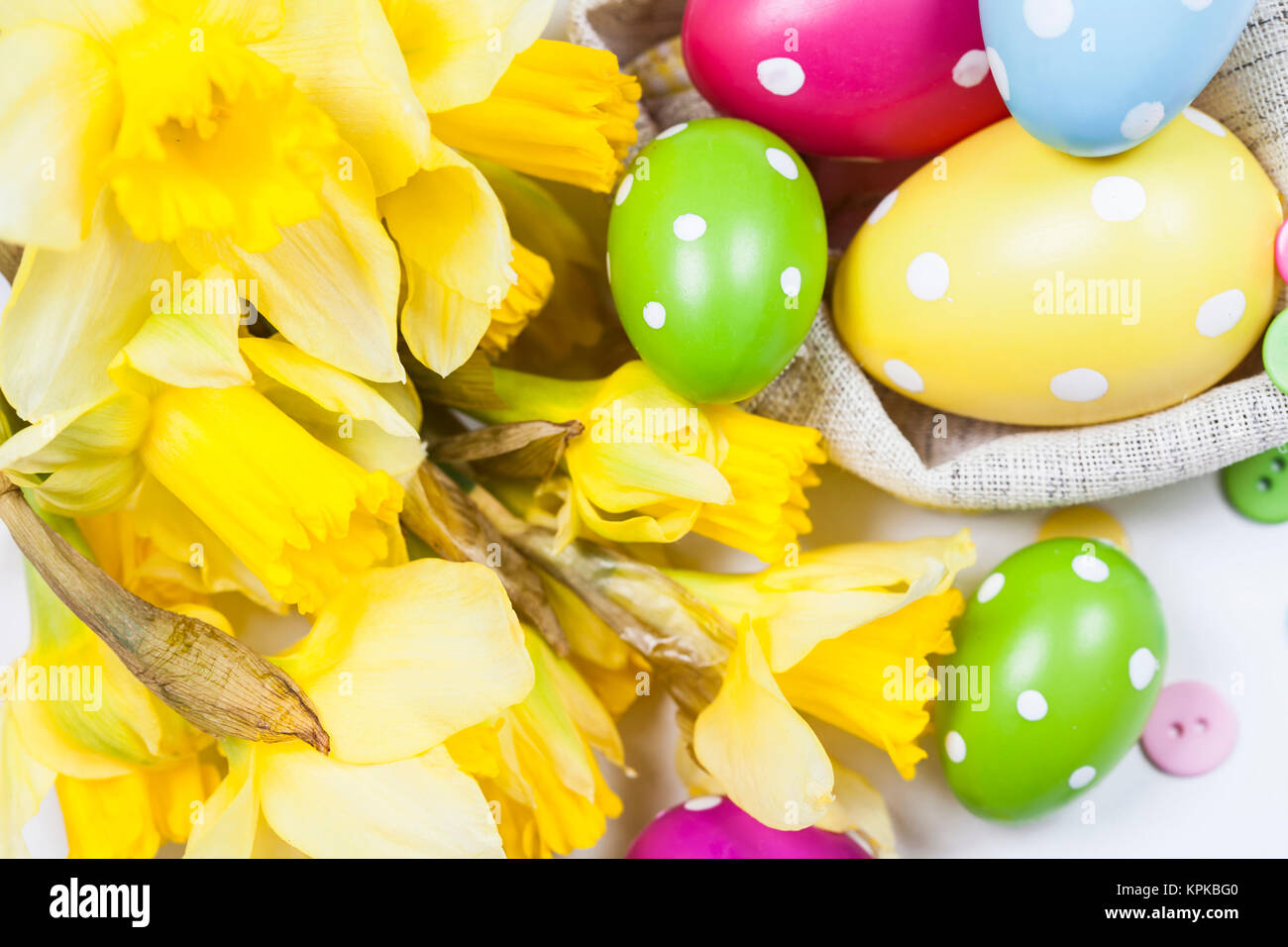 Easter background with colorful Easter eggs and a bouquet of yellow ...