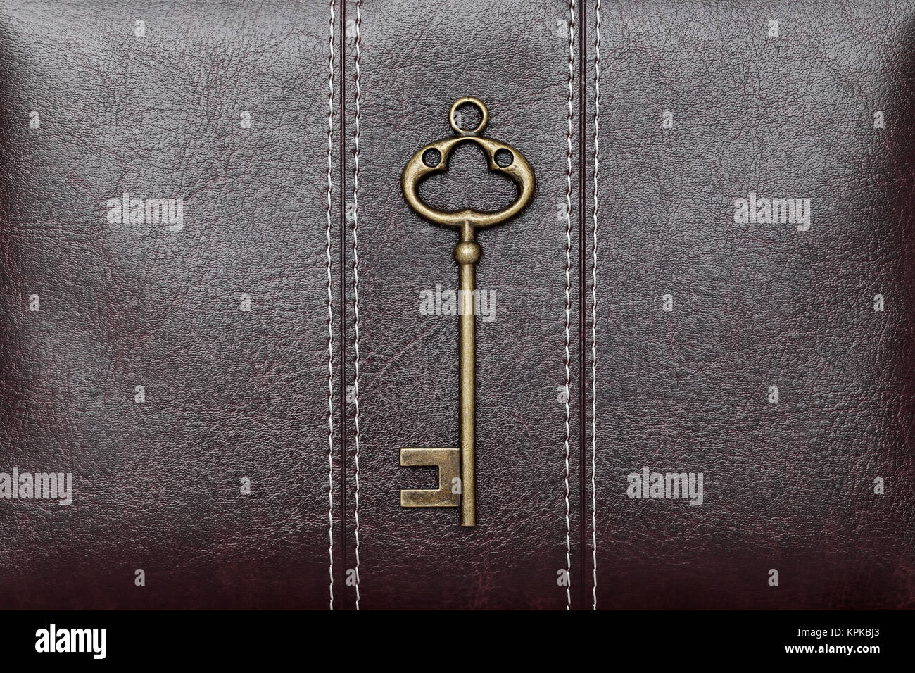 Vintage door key on a brown leather background Stock Photo - Alamy