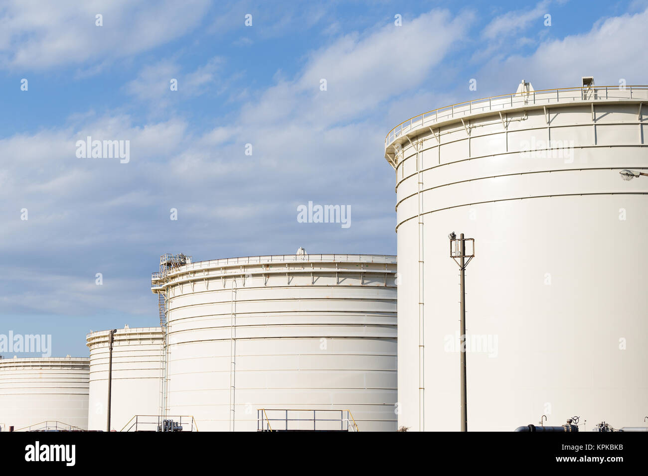 Oil tank with blue sky Stock Photo - Alamy