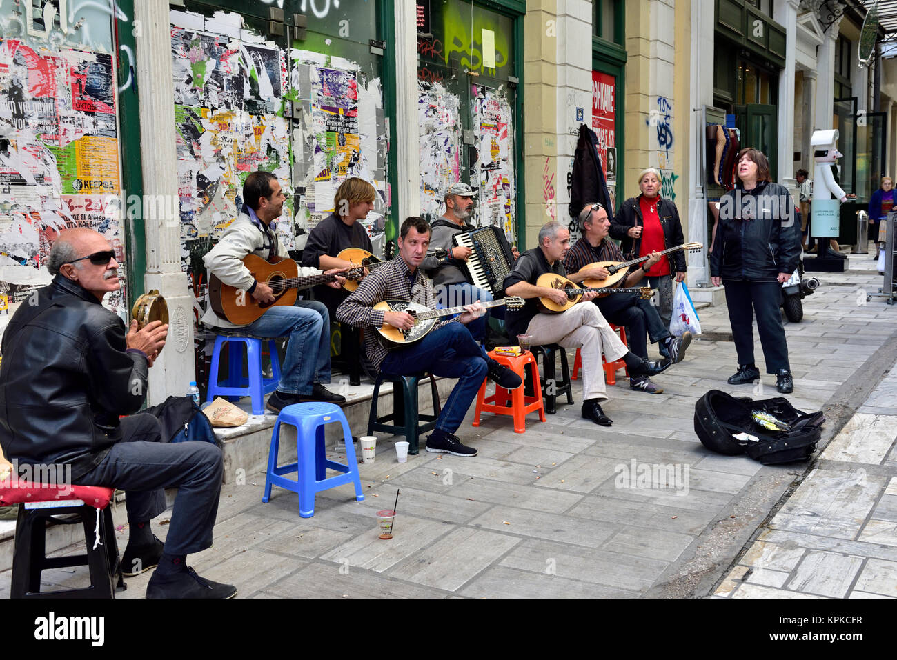 Group of musician buskers playing traditional instruments along ...