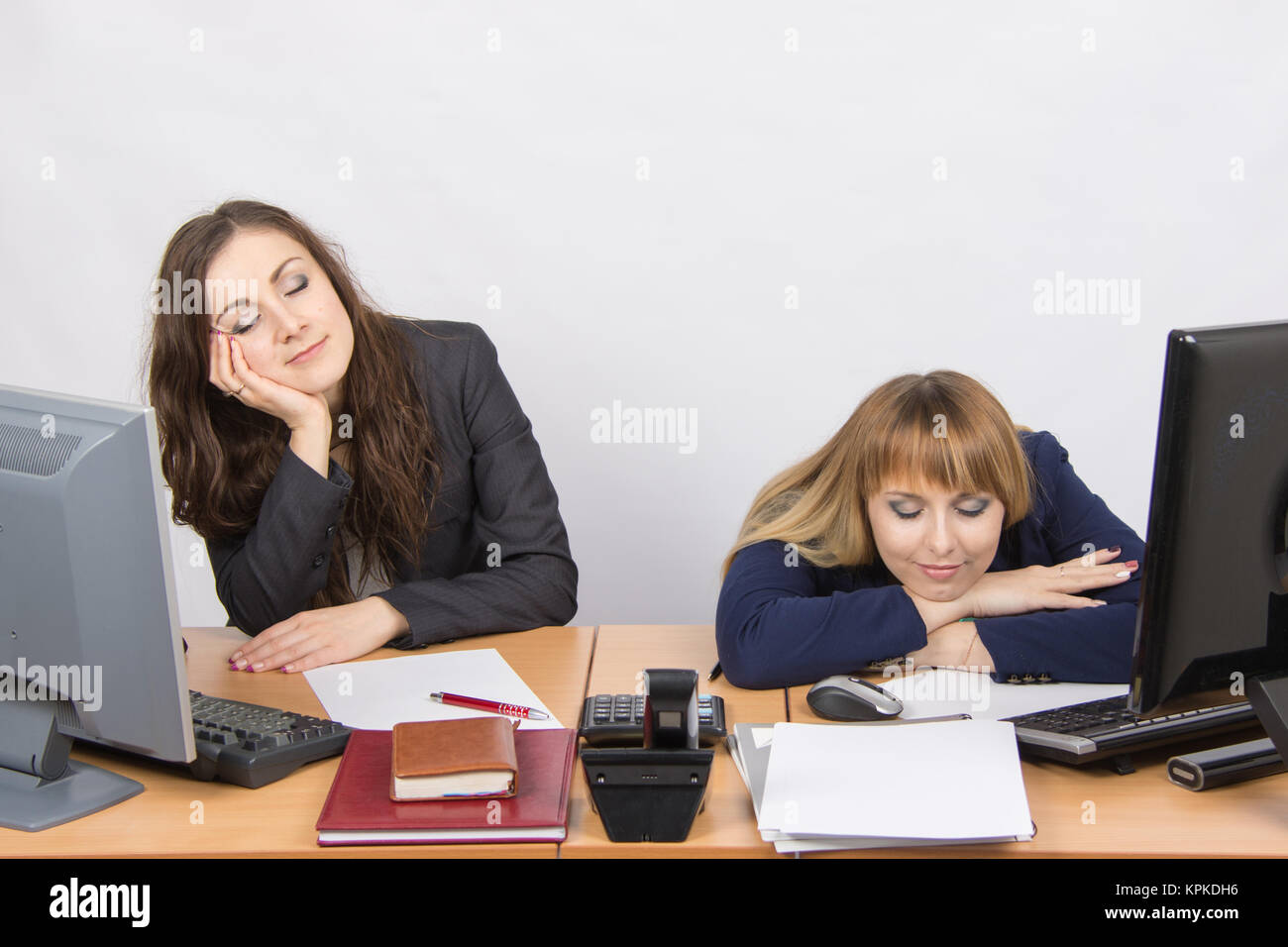 Two young office worker sleeping on the job Stock Photo - Alamy