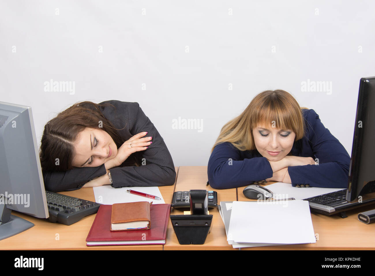Two young office worker sleeping on desk for computers Stock Photo - Alamy