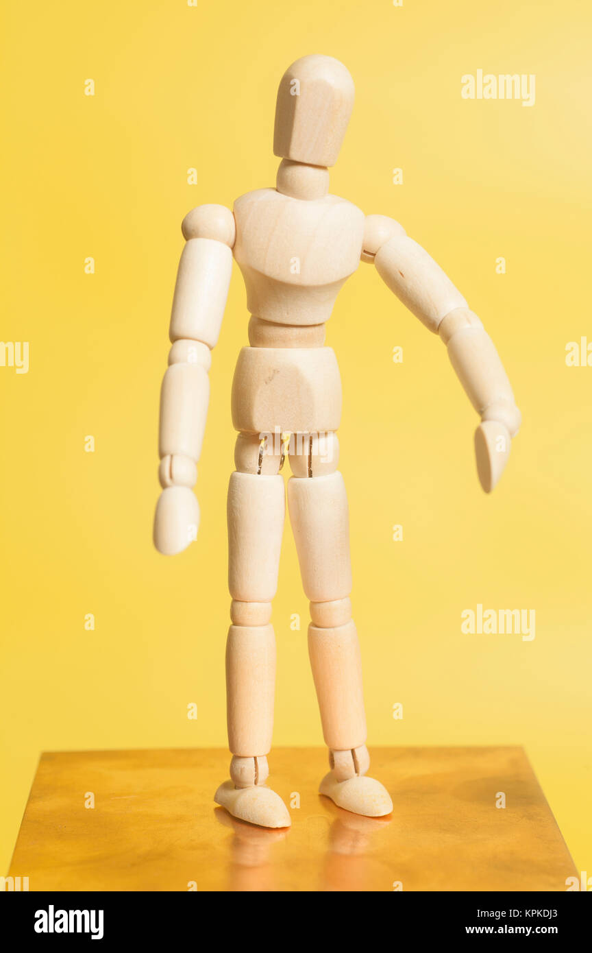 Wooden artist mannequin on a yellow background Stock Photo - Alamy