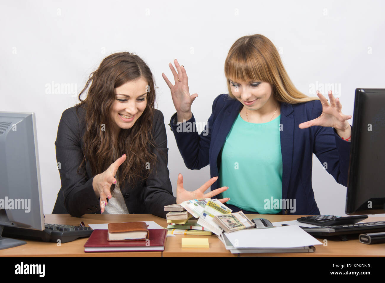 Two office employee greedy hands to pull a wad of money Stock Photo - Alamy