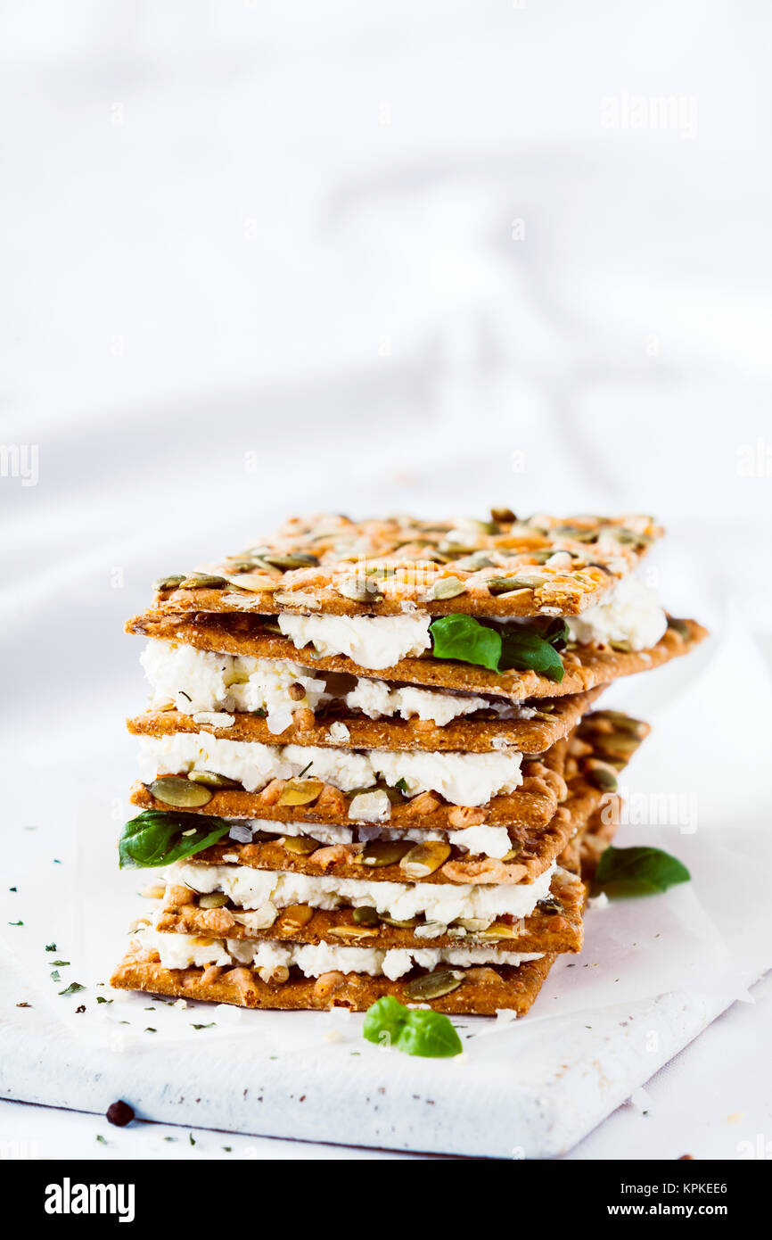 Delicious crispy crackers with alternating layers of cheese garnished ...