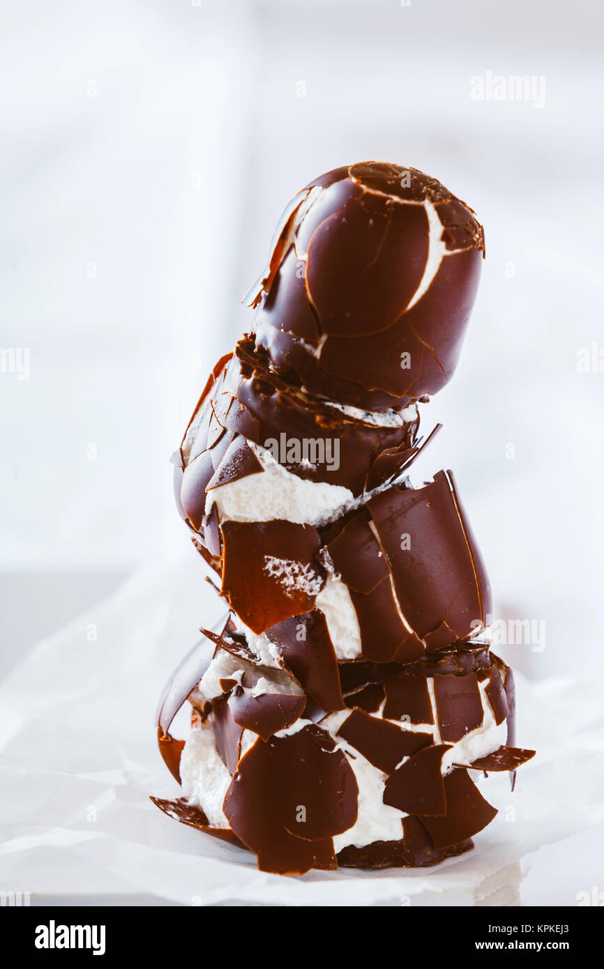 Cracked damaged chocolate coated individual ice cream dessert on the ...
