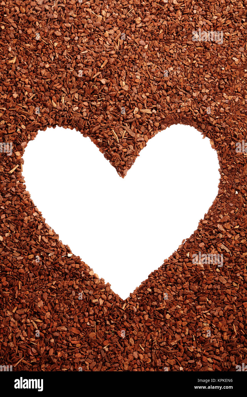 Pine bark mulch surrounding single white loving heart symbol with copy ...