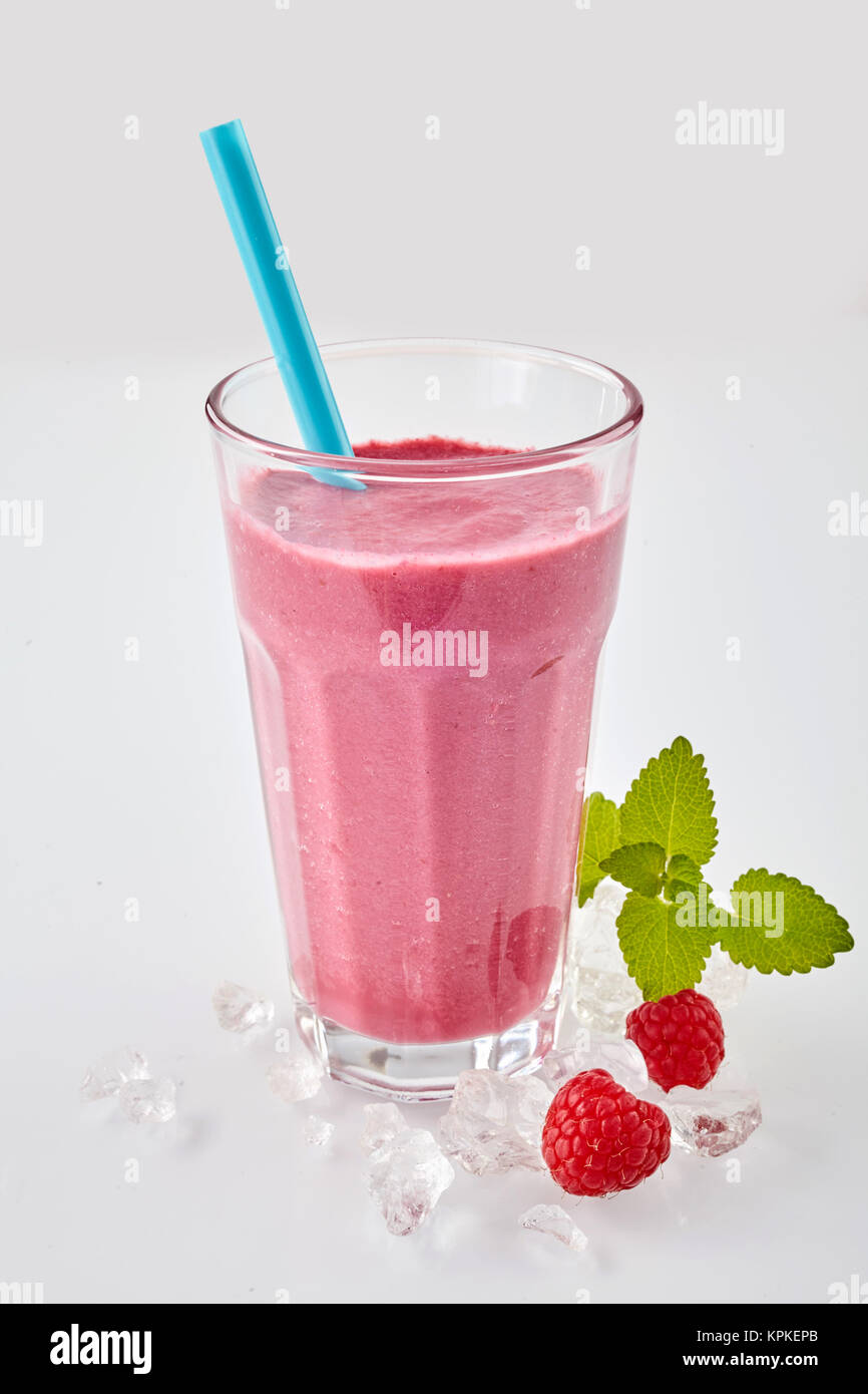 Fresh raspberry and yogurt smoothie served in a tall glass chilled with ...