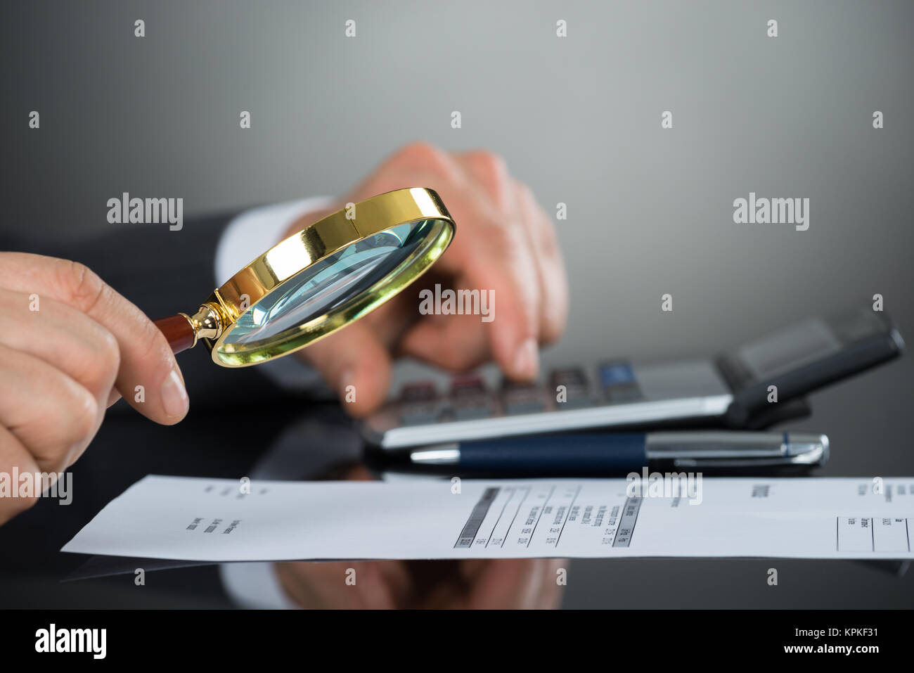 Businessman Inspecting Document With Magnifying Glass Stock Photo - Alamy