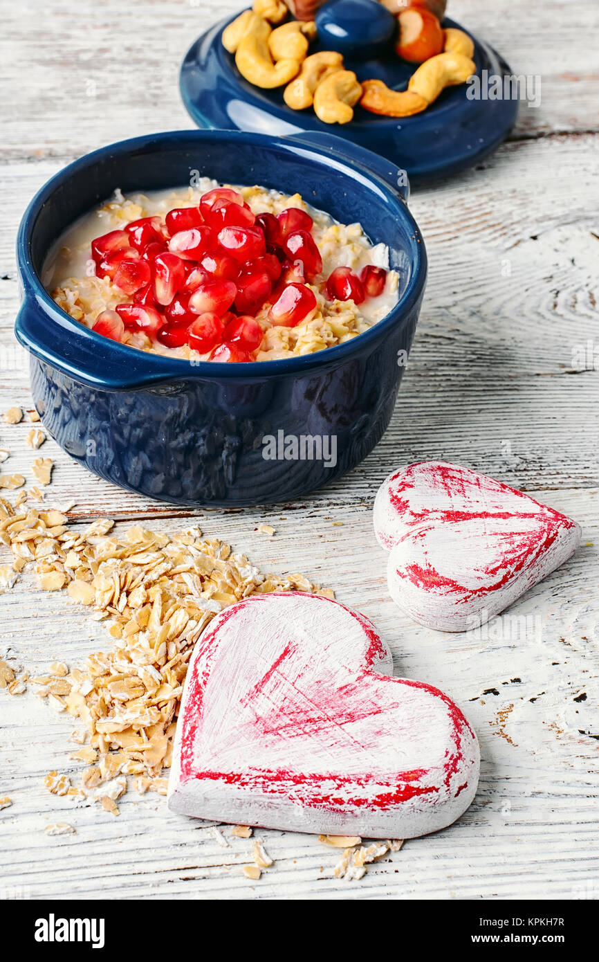 Blue pot of porridge decorated with pomegranate seeds Stock Photo - Alamy