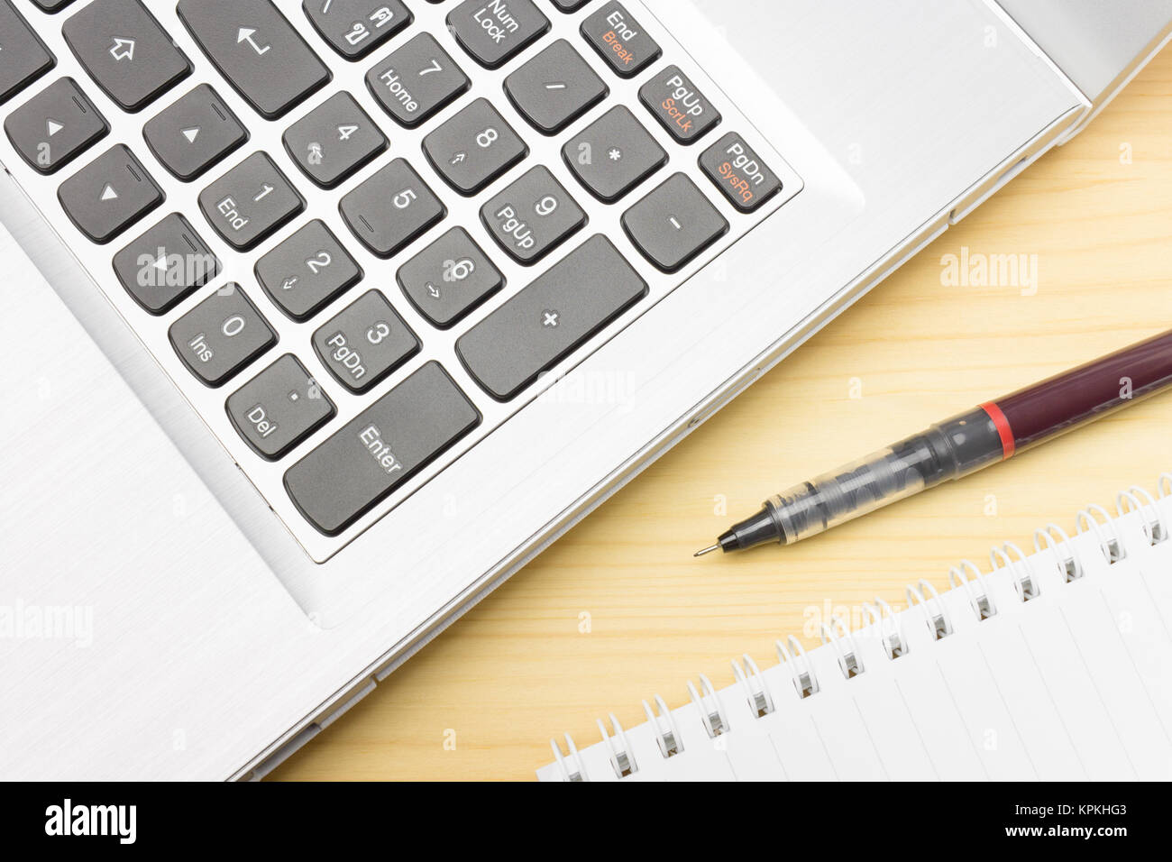 Silver Laptop and Notebook and Pen on Wood Table Stock Photo - Alamy