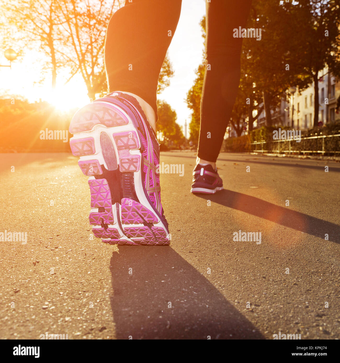 Woman running in the street Stock Photo - Alamy