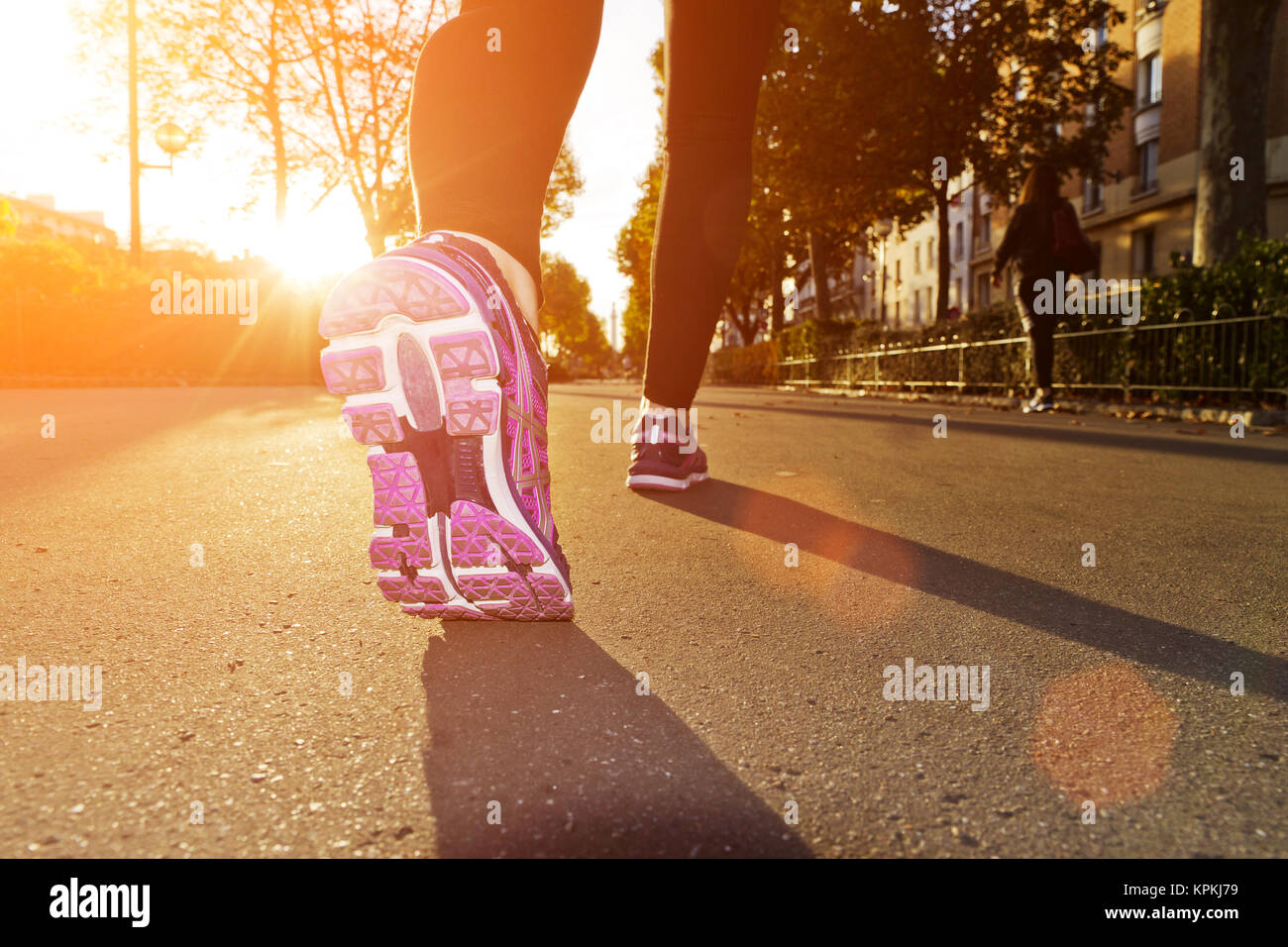 Woman running in the street Stock Photo - Alamy