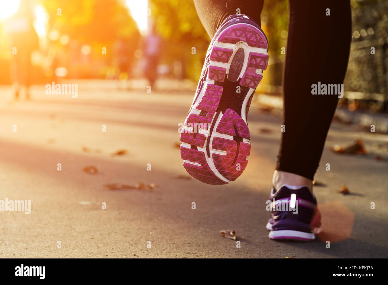 Woman running in the street Stock Photo - Alamy