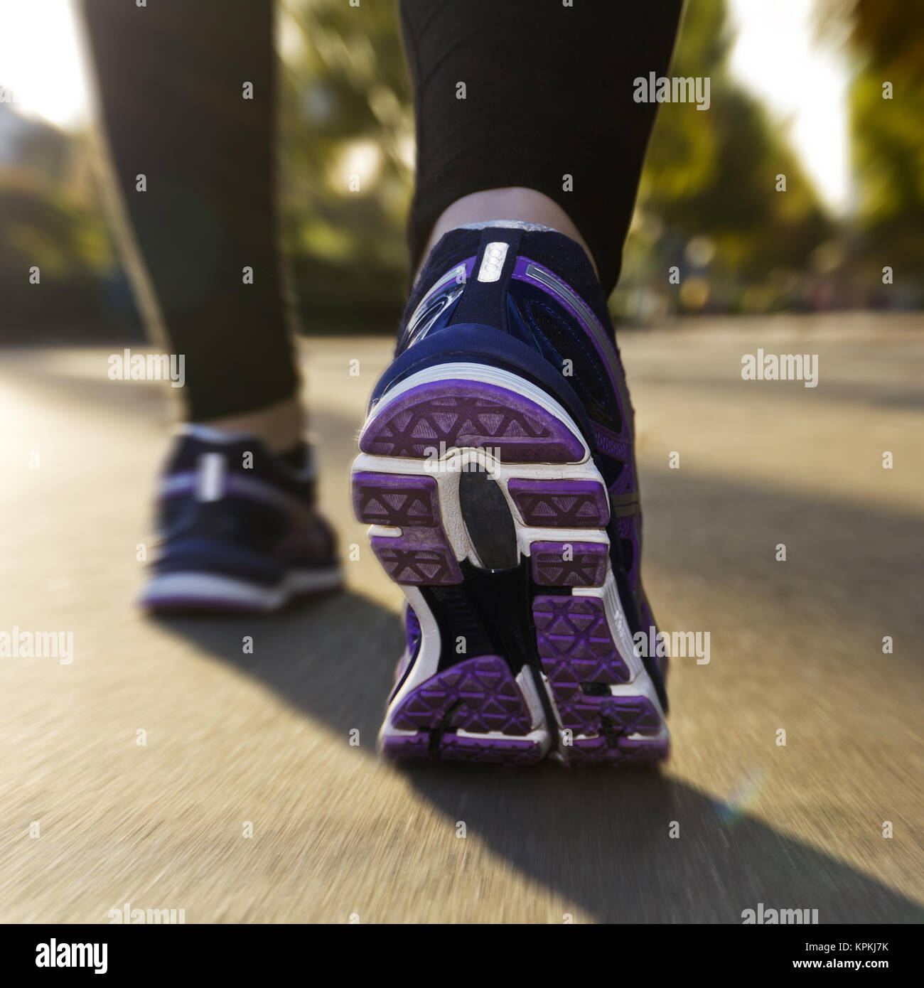 Woman running in the street Stock Photo - Alamy