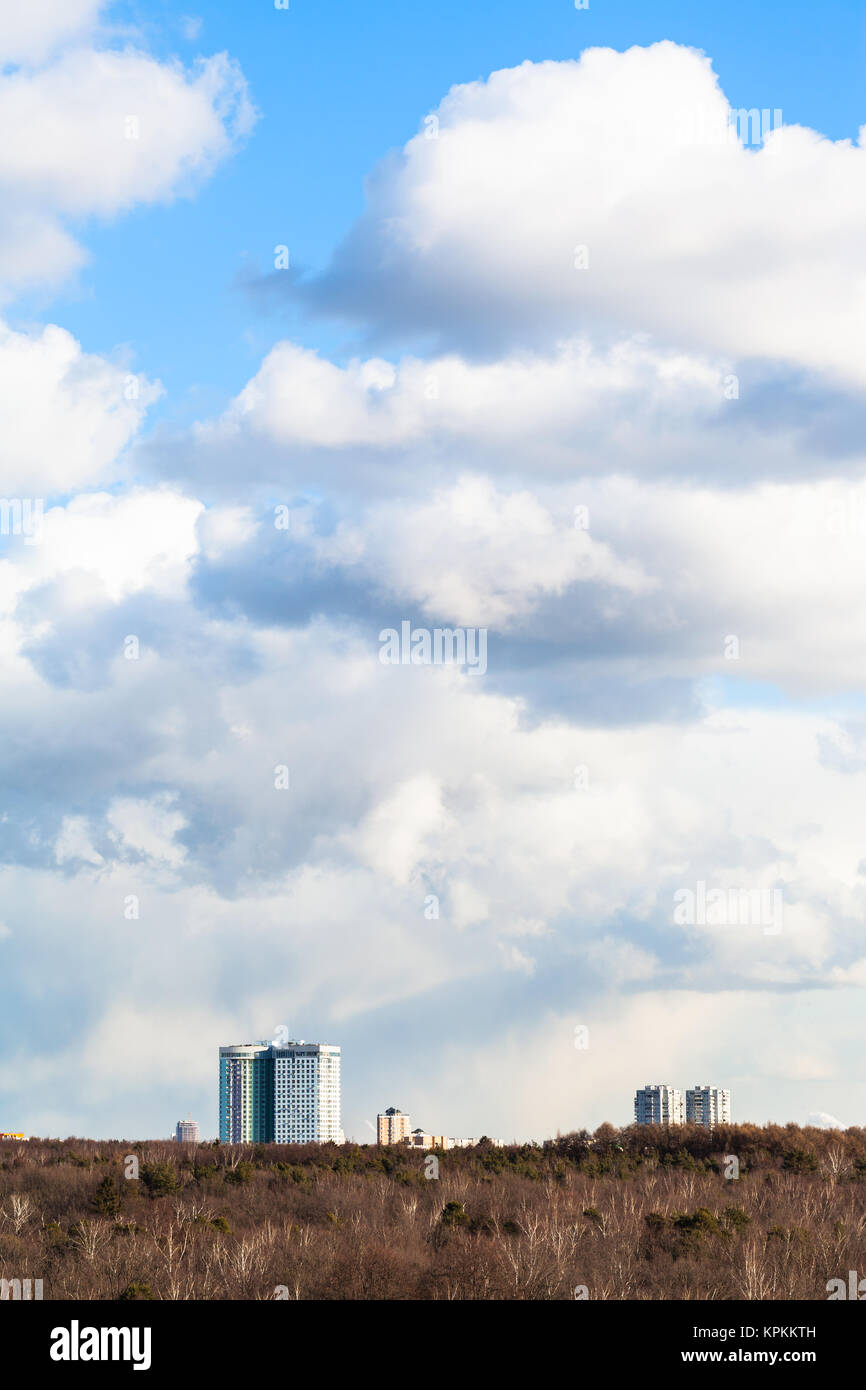 cumulus clouds in sky over buildings and woods Stock Photo - Alamy