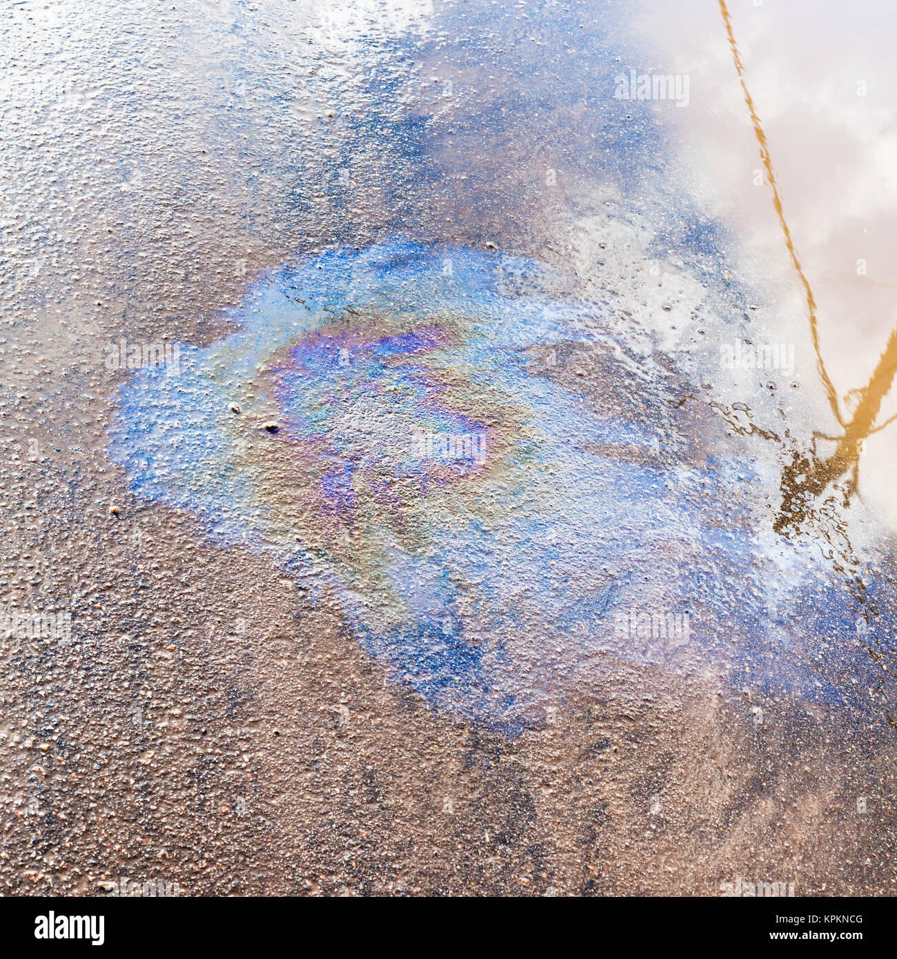 iridescent film of engine oil on asphalt pavement Stock Photo - Alamy