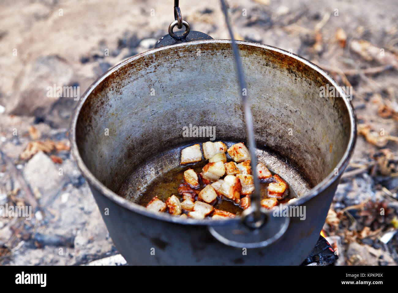 Outdoor cooking. Making cracklings from fat in a pot Stock Photo - Alamy