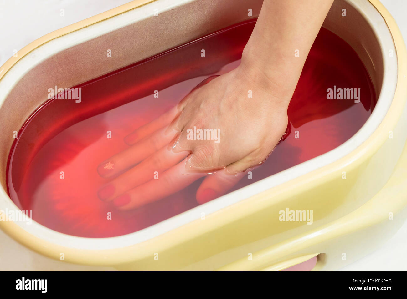Process paraffin treatment of female hands in beauty salon Stock Photo ...