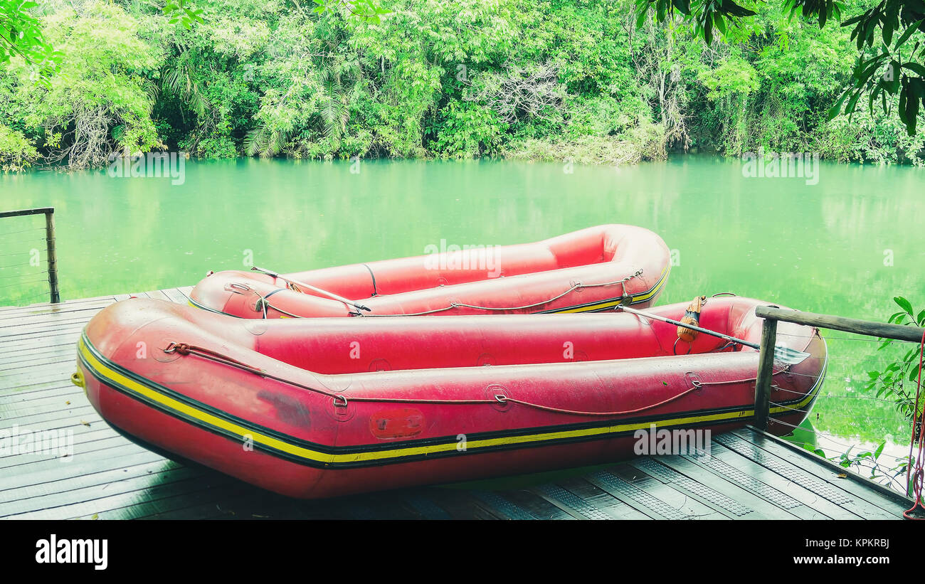 Red boat on the river. River with green water, beautiful nature ...