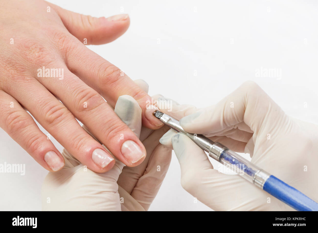 The process of the master's work in the manicure salon of female nails ...