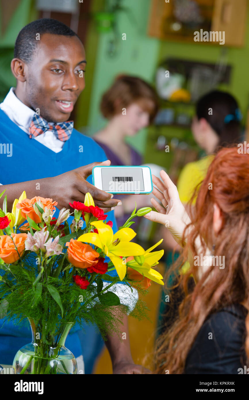 Smiling Flower Shop Customer using Electronic Coupon Stock Photo - Alamy